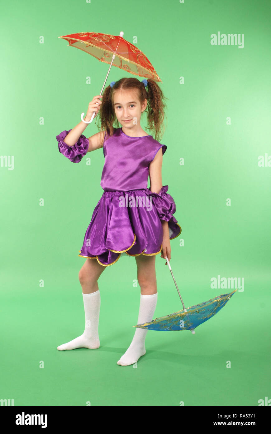 Pretty girl posing for the camera, in a violet short dress. Isolated on ...
