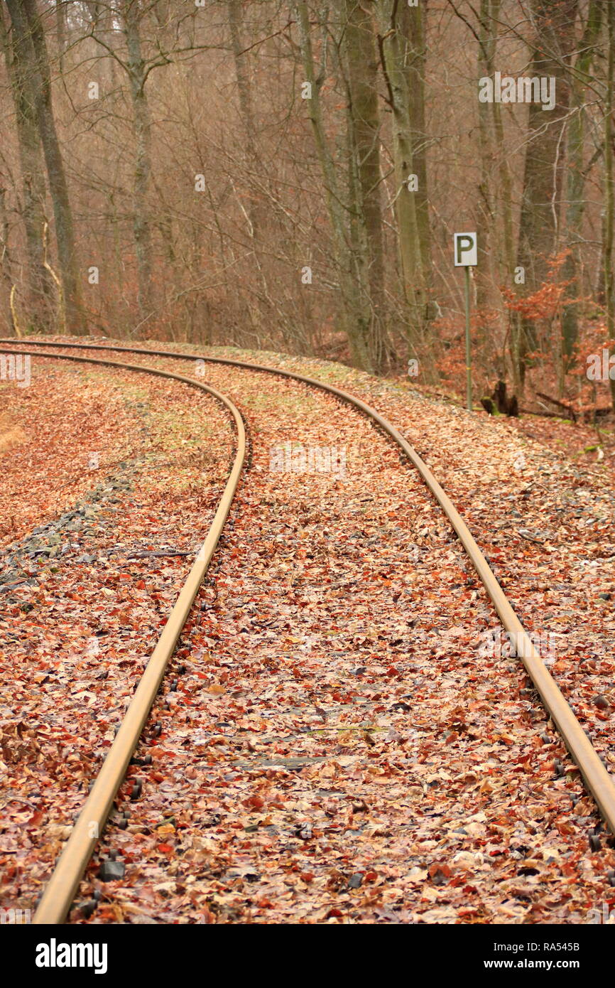 Railway tracks run away from the viewer in a curve Stock Photo - Alamy