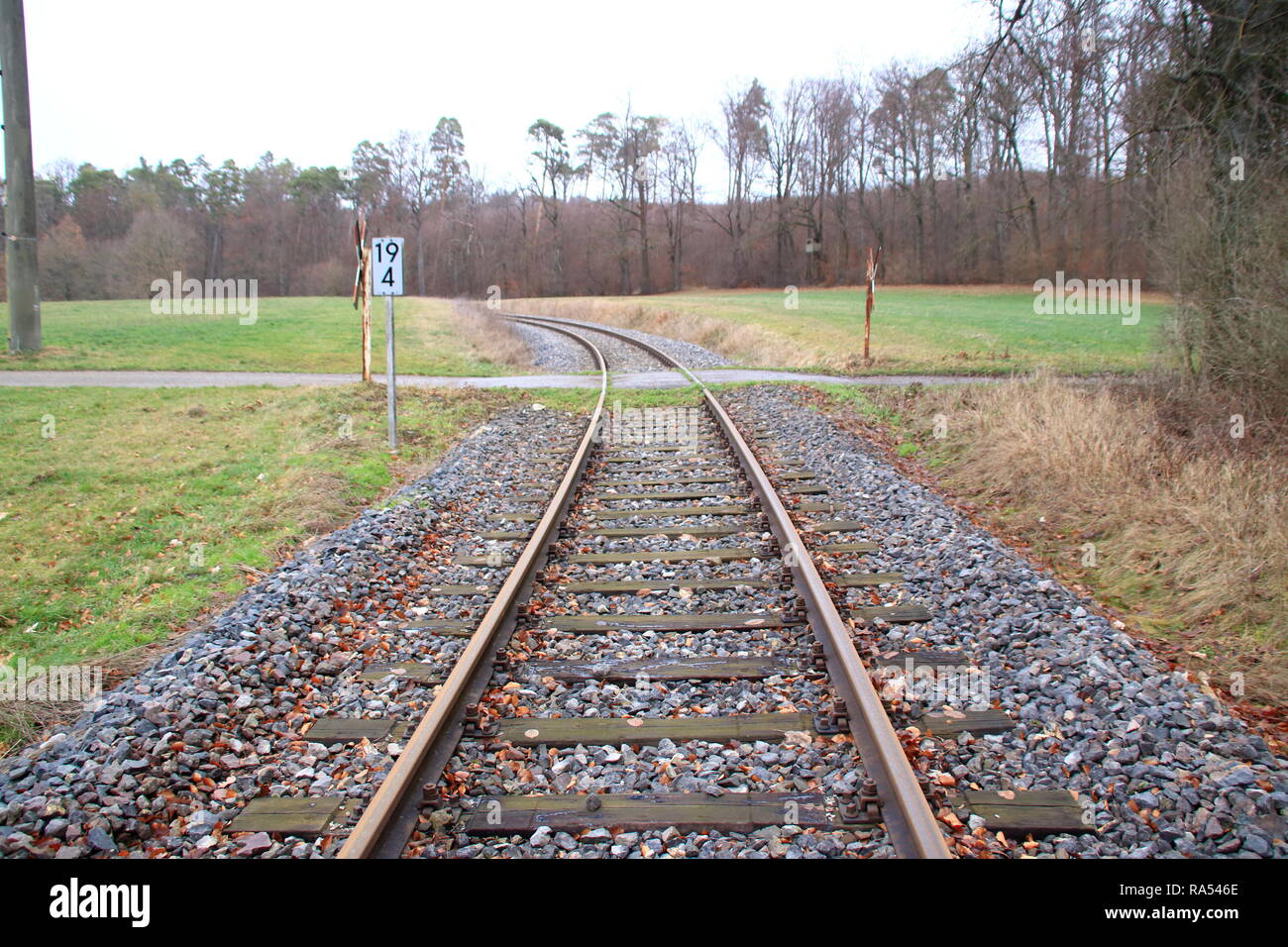 Railway tracks run away from the viewer in a curve Stock Photo - Alamy