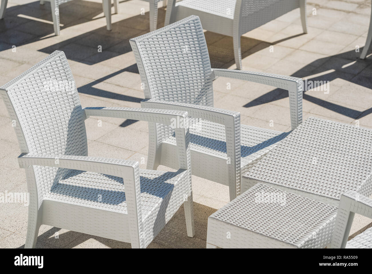 White tables and chairs at street cafe. Horizontal color photography ...