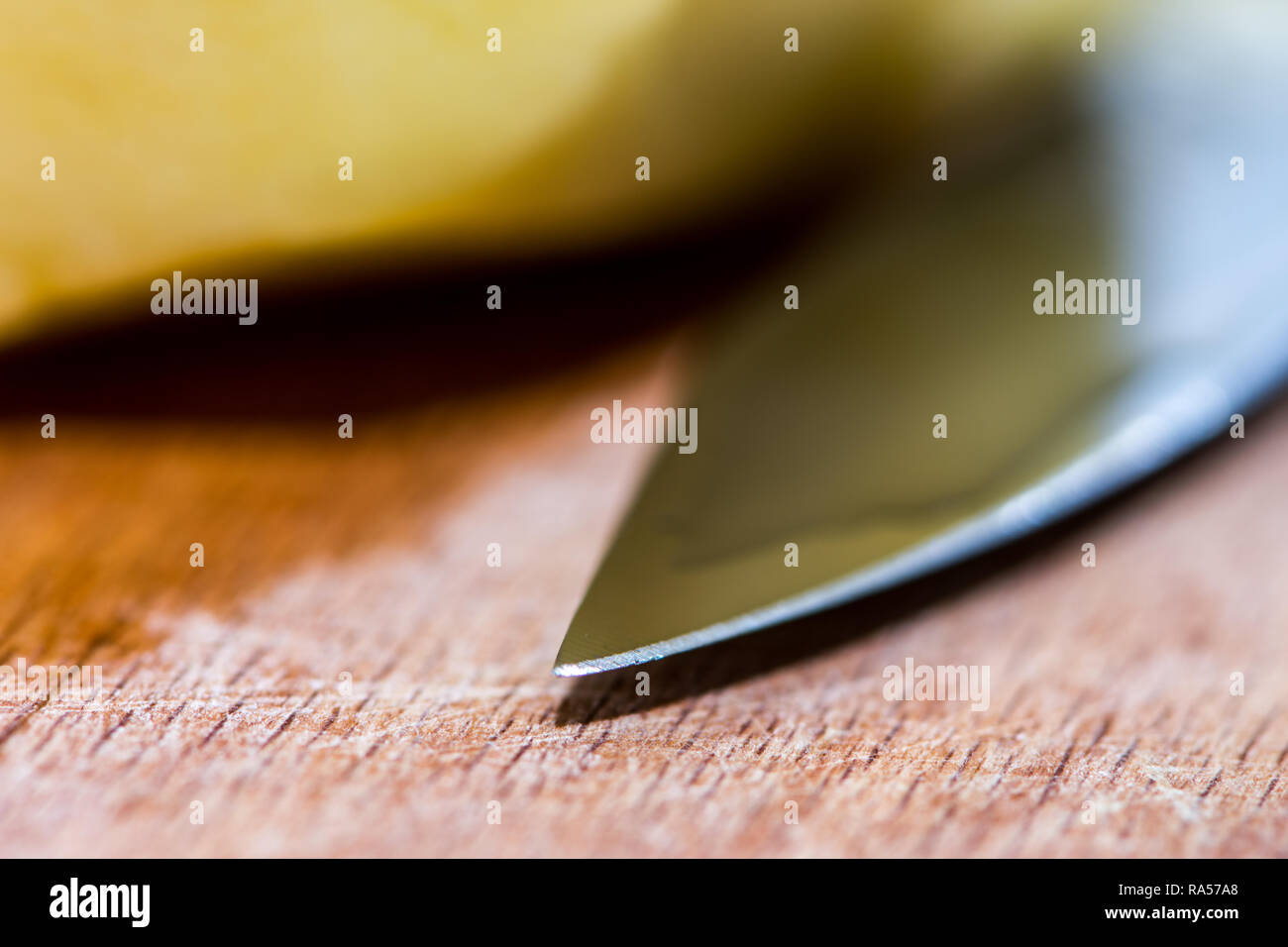 Metallic side of knife cutting the potato Stock Photo - Alamy