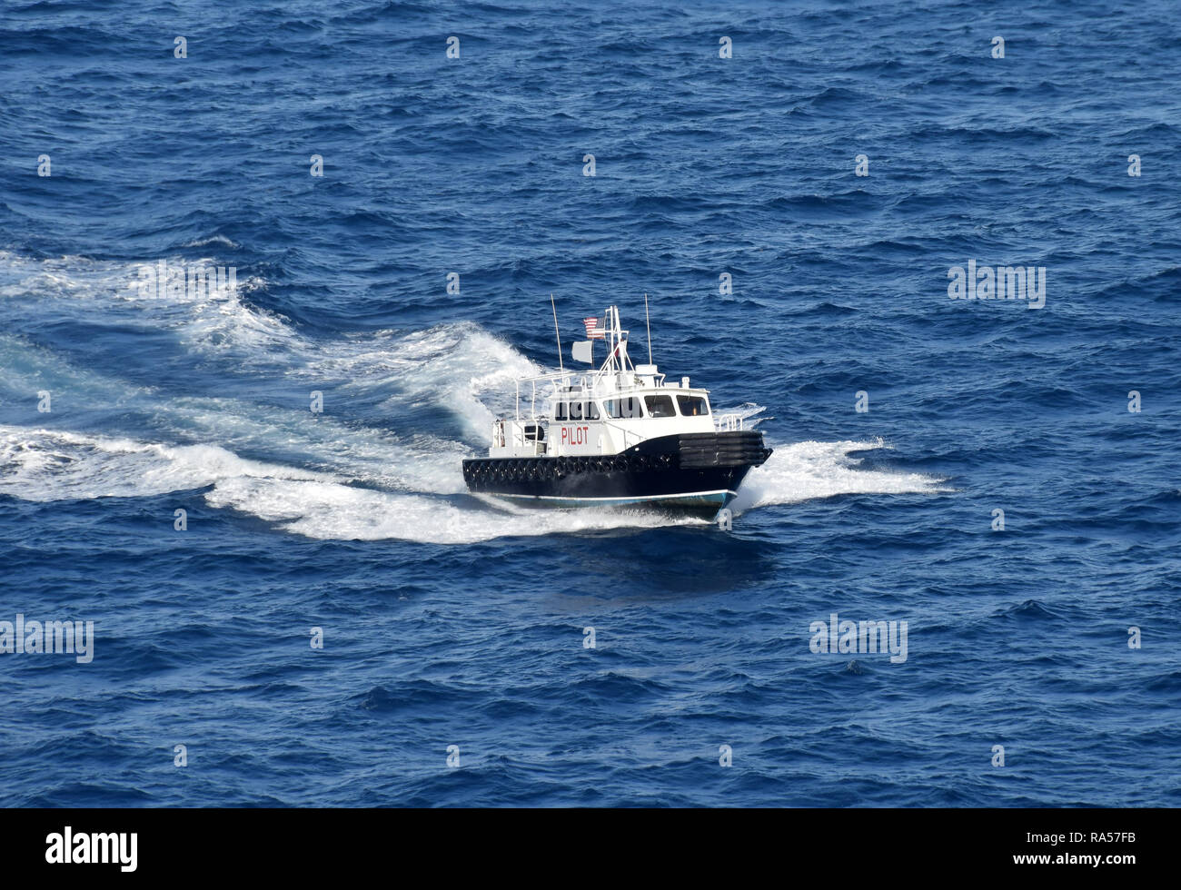 Pilot boat helping guide ships into port Stock Photo - Alamy