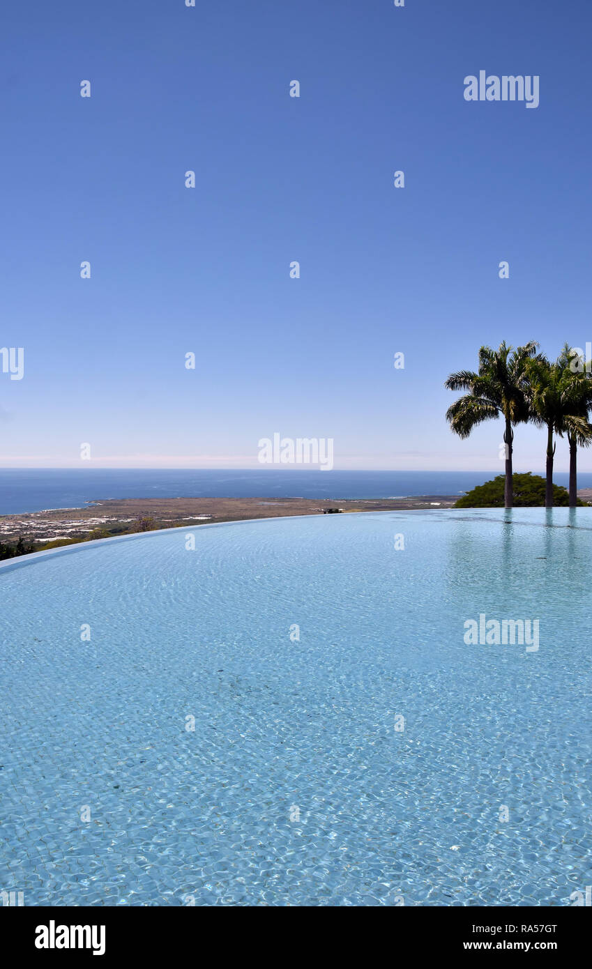 Blue water from infinity pool overlooking tropical coast in Hawaii ...