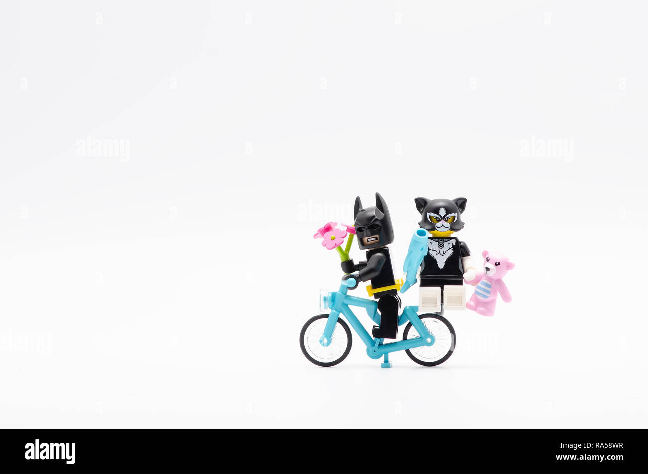 batman riding bicycle with cat women. isolated on white background ...