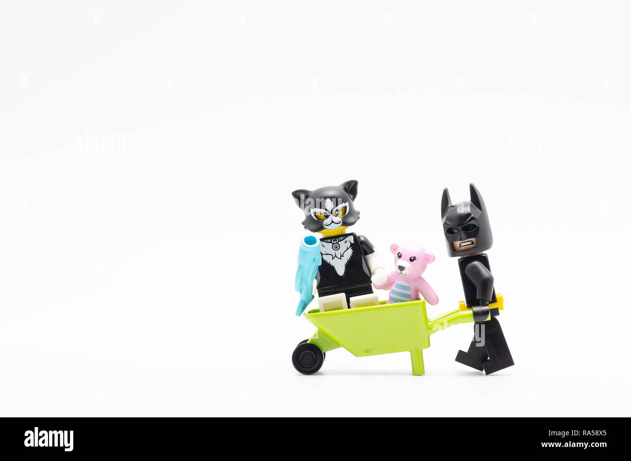 batman pushing wheelbarrow with cat women sitting on it. Lego ...
