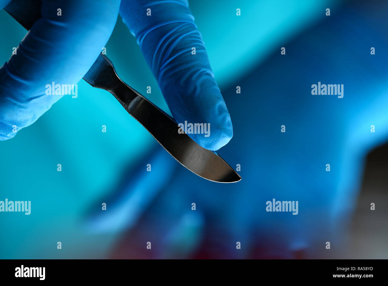 Surgeon arms in sterile uniform holding sharp knife Stock Photo - Alamy