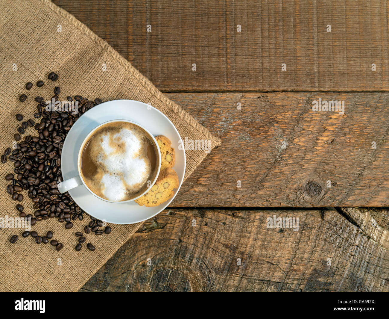 Fresh roasted coffee, latte or cappuccino on a rustic wood background ...