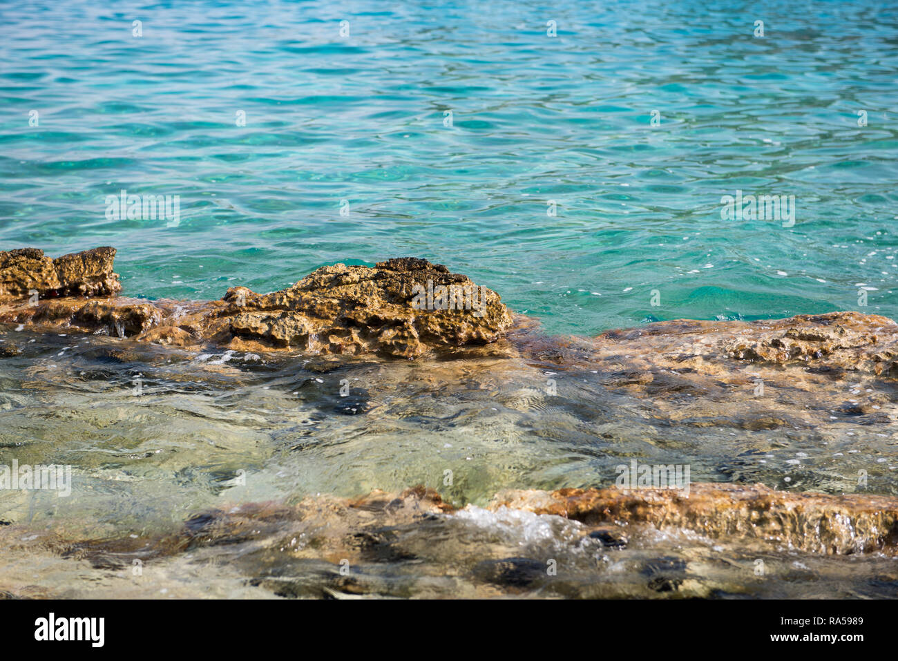 Sharp rocks, stones in a sea. Beautiful clean sea water Stock Photo - Alamy