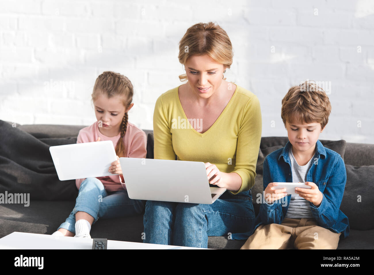 mother and beautiful children using digital devices at home Stock Photo ...