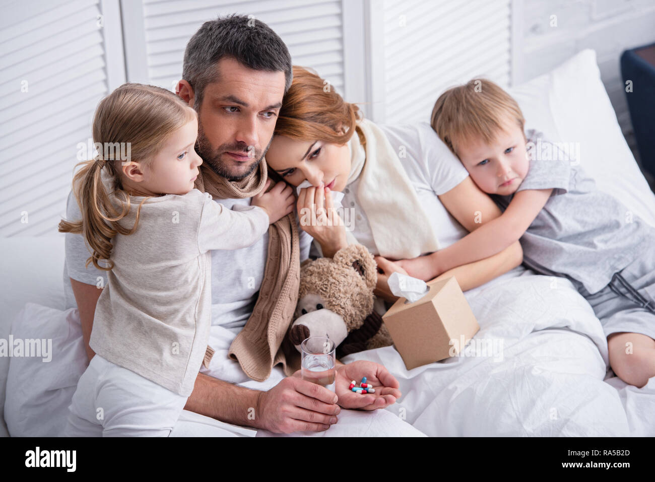 adorable siblings hugging sick parents in bedroom Stock Photo - Alamy