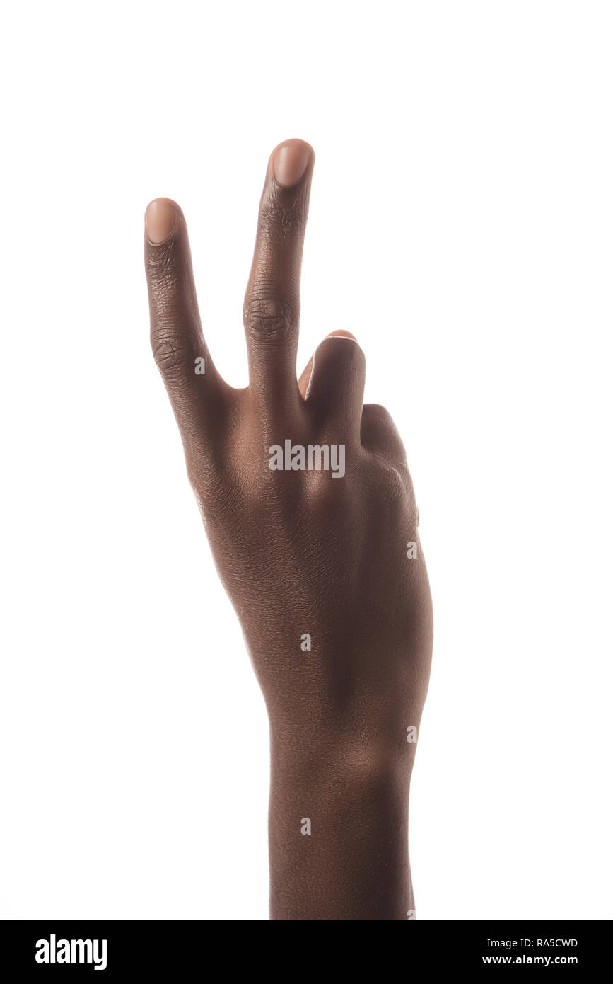 partial view of african american man showing number 2 in sign language ...