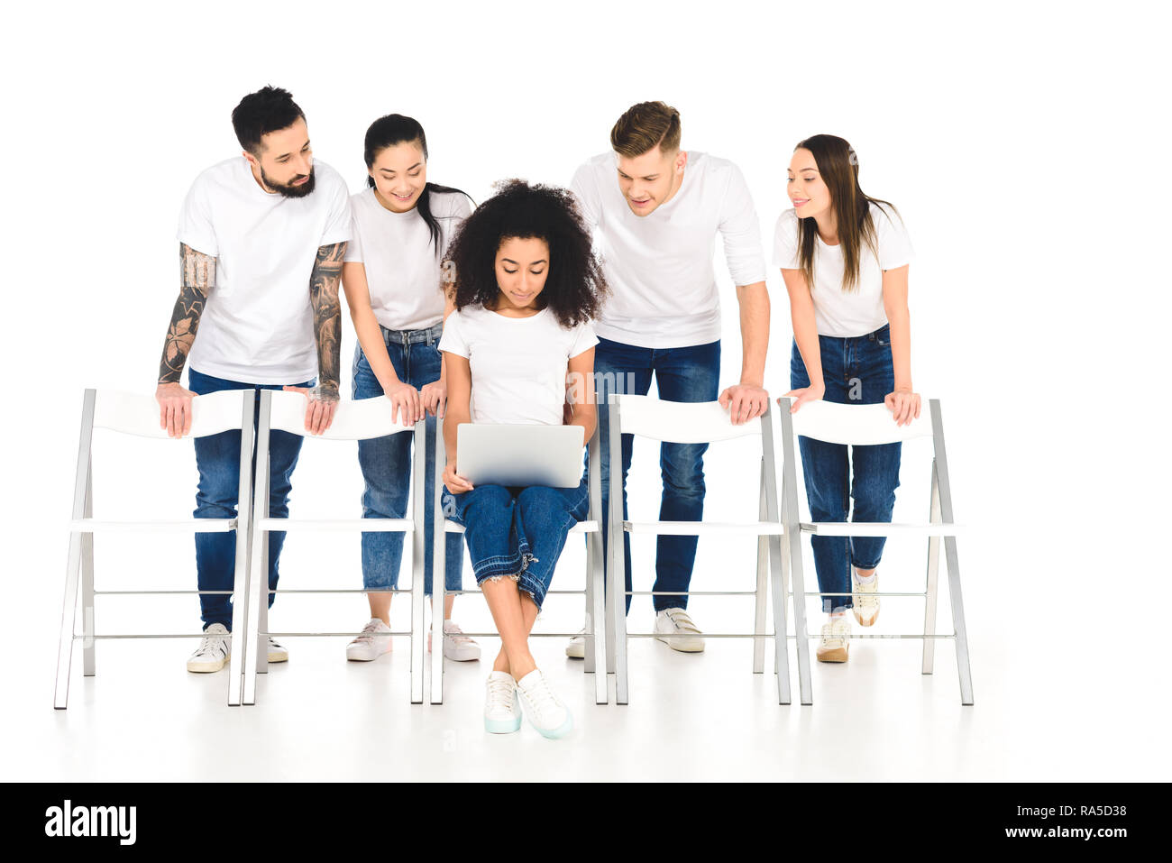 african american woman using laptop while multicultural group of young ...
