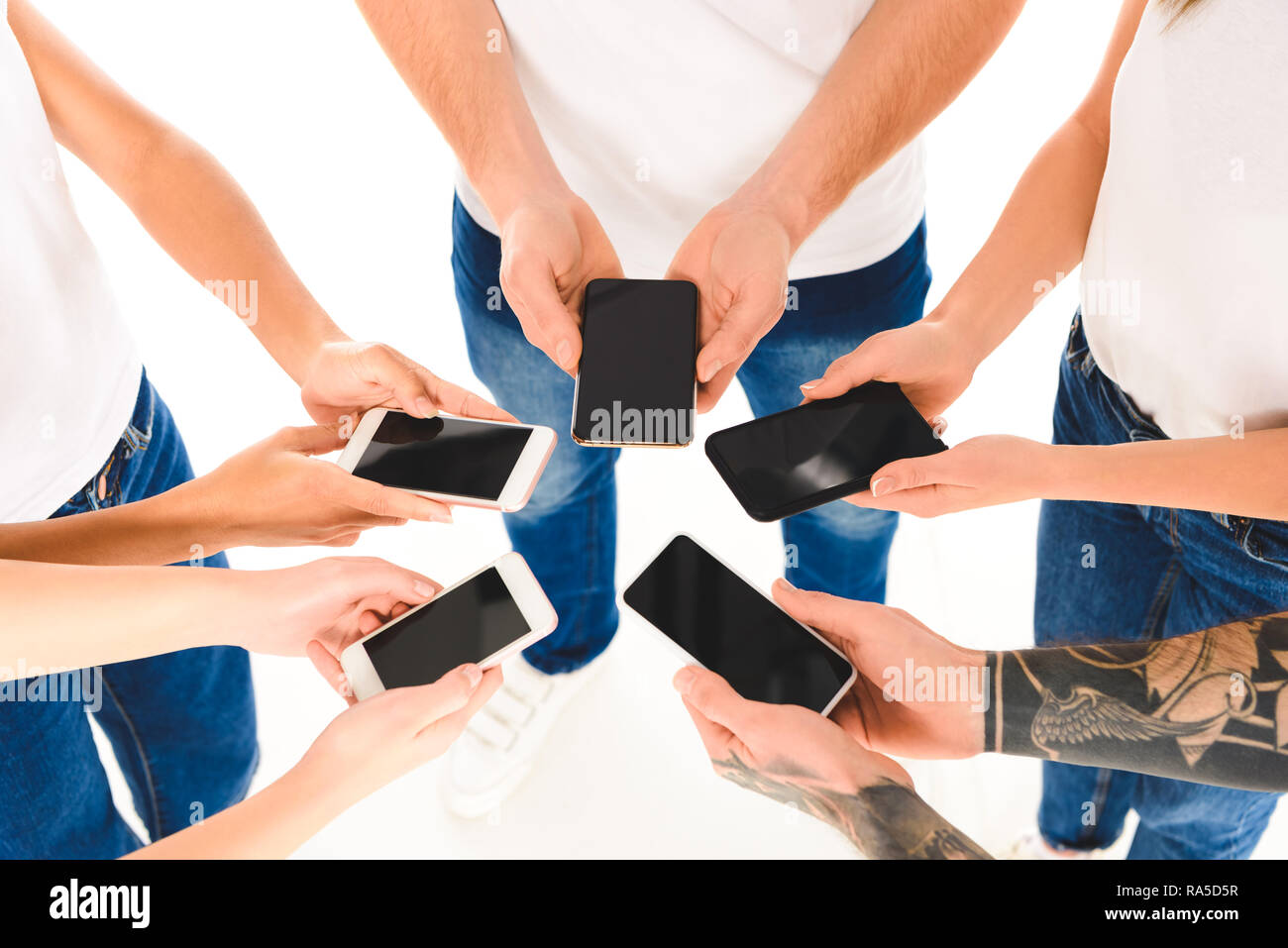 cropped view of group of people standing in circle and holding ...