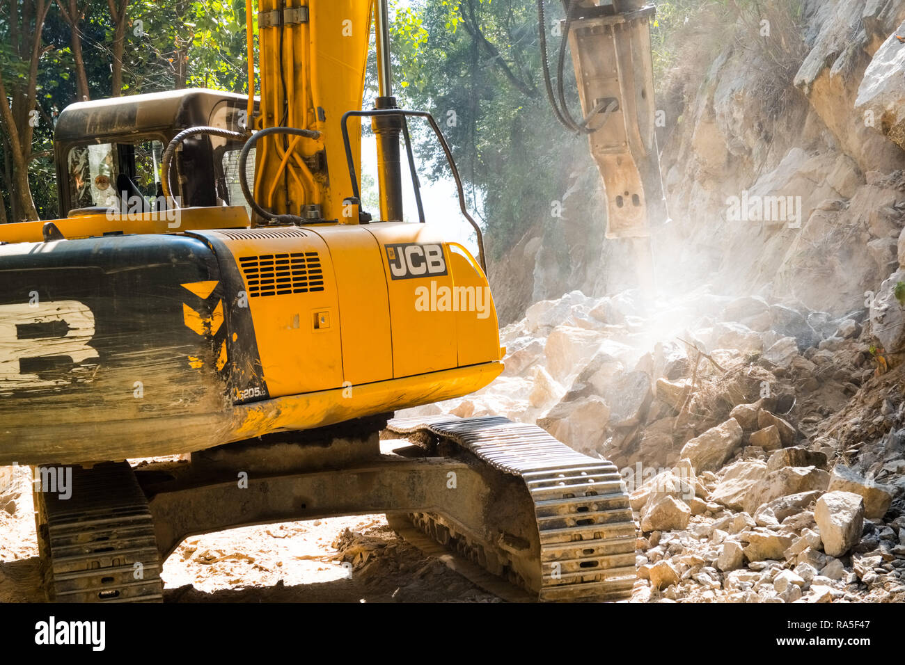 JCB on road building site on the Annapurna Circuit trek in the Nepal ...