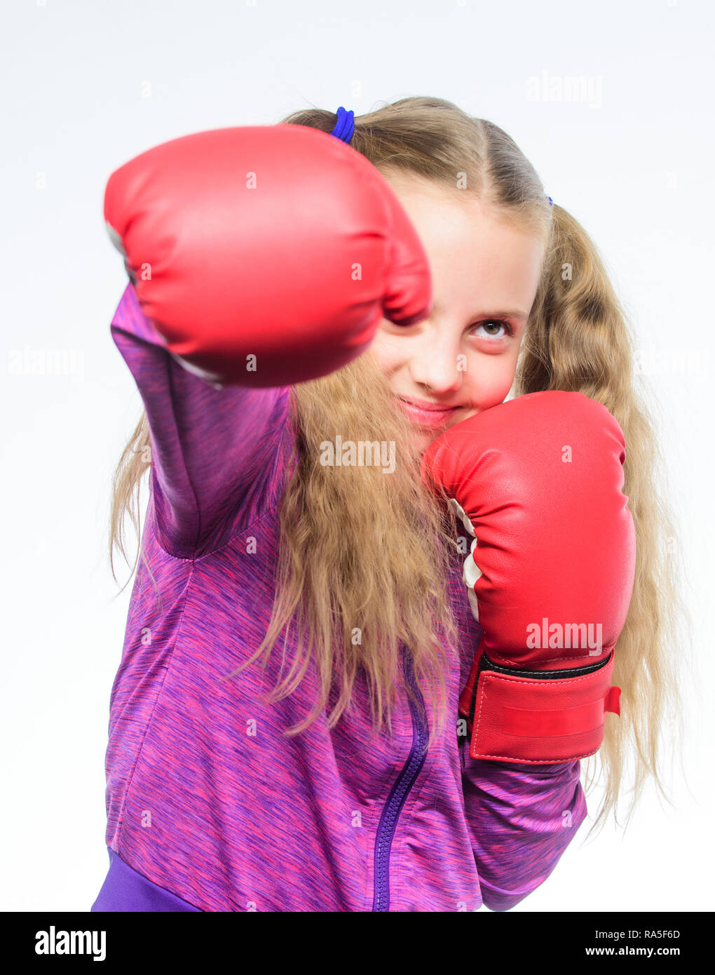 little girl in boxing gloves punching. Sport and sportswear fashion ...