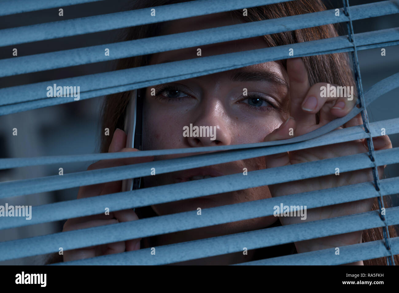 The woman with the phone peeping out the window Stock Photo - Alamy