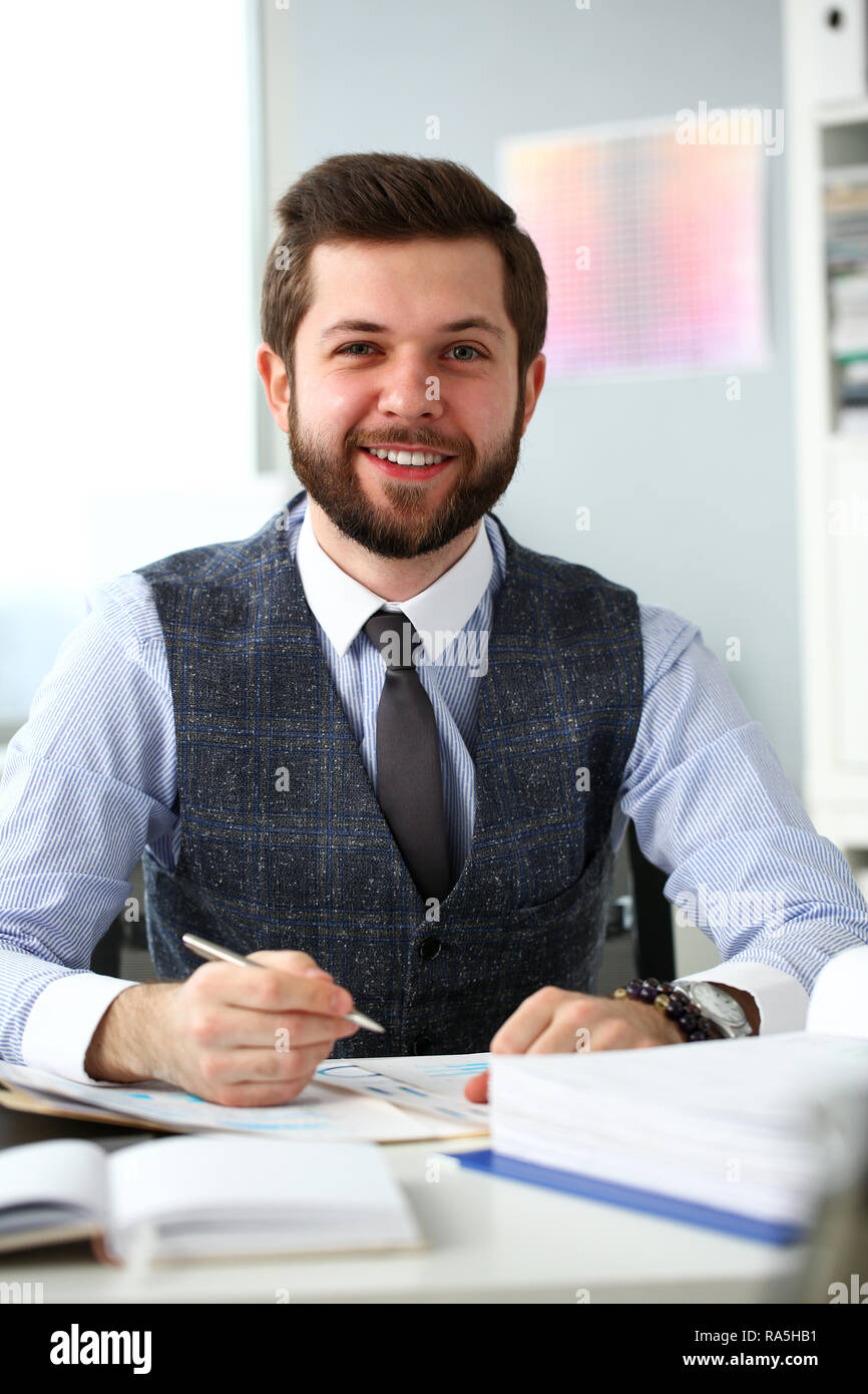 Handsome smiling bearded clerk man at office workplace Stock Photo - Alamy