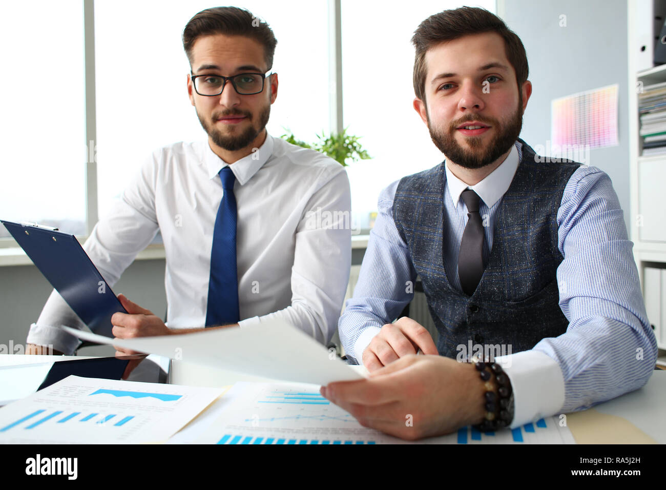 Group of businessmen with financial graph and silver pen Stock Photo ...