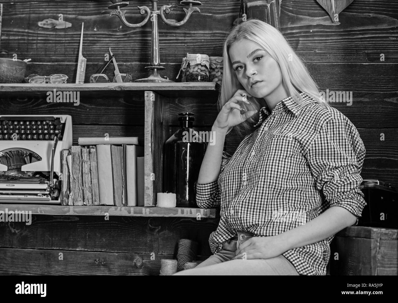 Girl sits and relaxing in house of gamekeeper. Girl in casual outfit ...