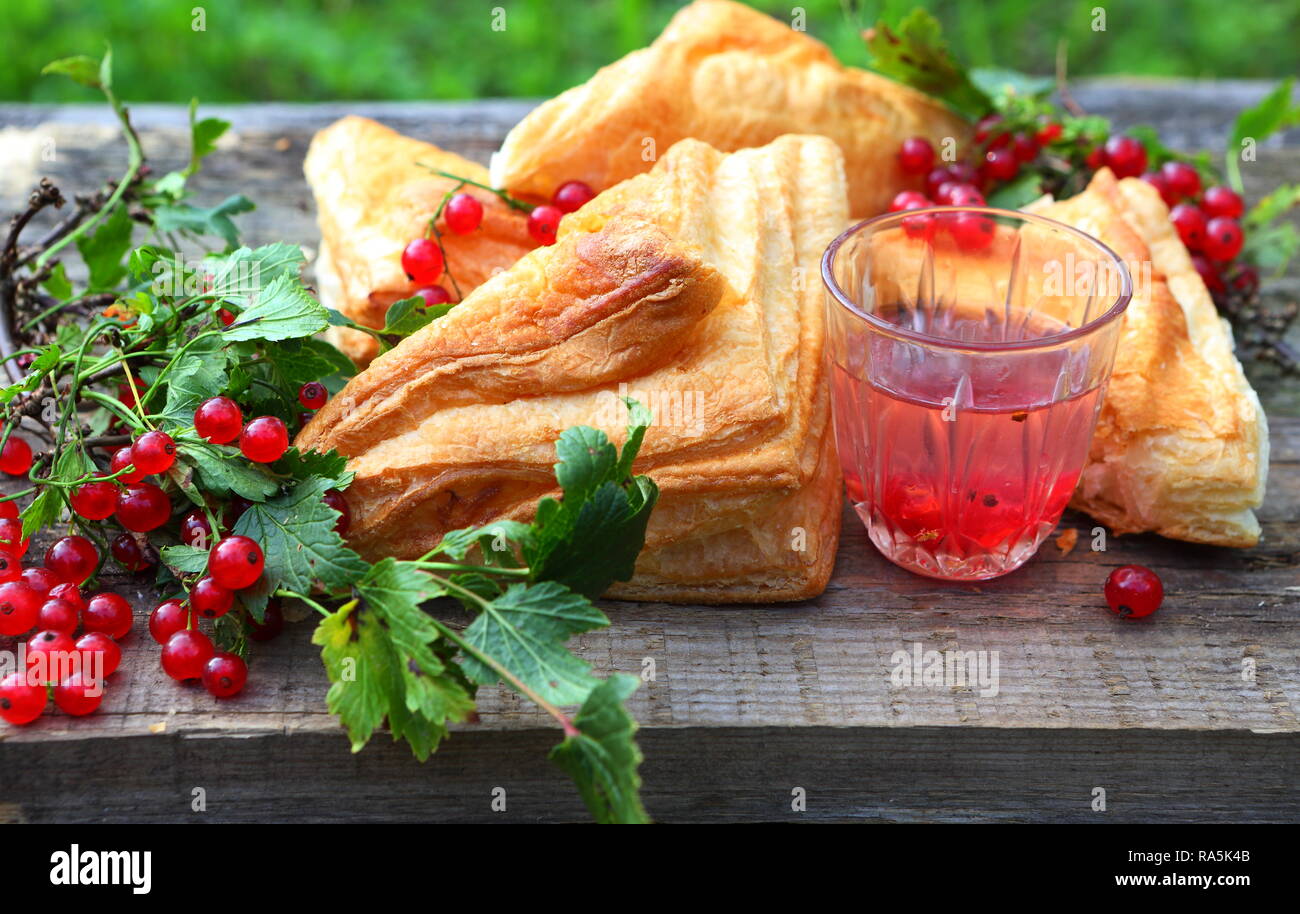 Still life with currants and puff pastries Stock Photo - Alamy