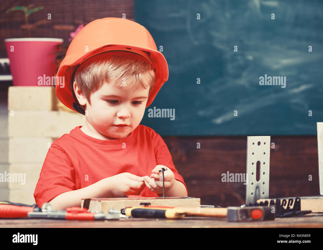 Childhood concept. Boy play as builder or repairer, work with tools ...
