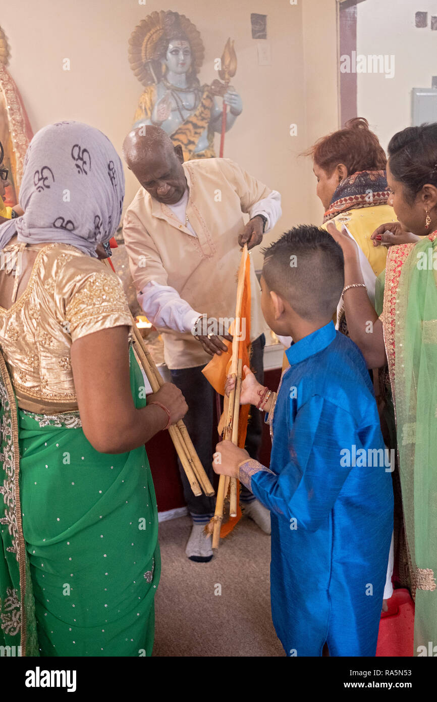 Devout Hindu worshippers tie victory flags to bamboo poles at a Shakti ...