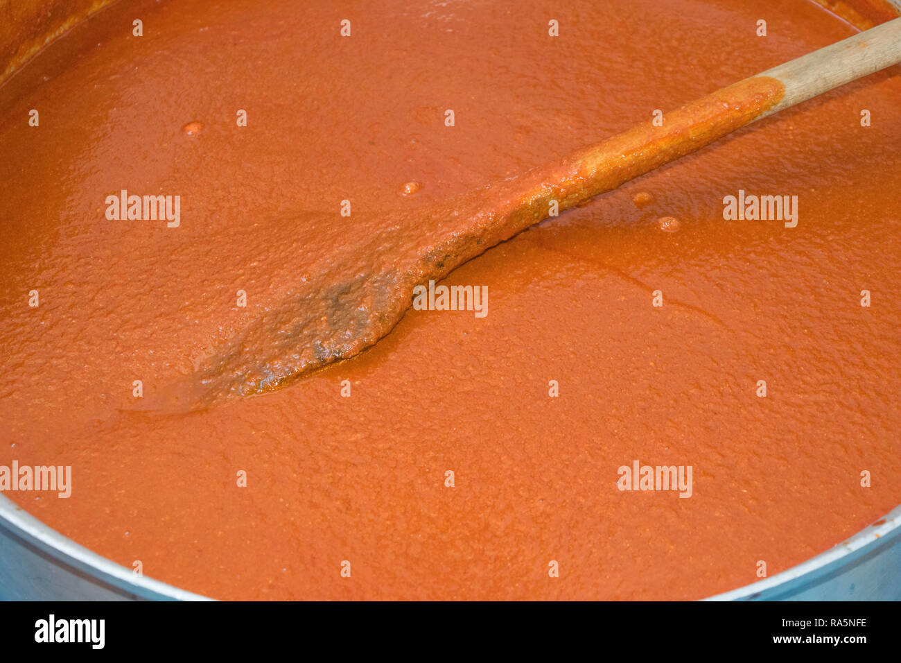 A big metal pot filled with Mole sauce, and a wooden spoon Stock Photo ...