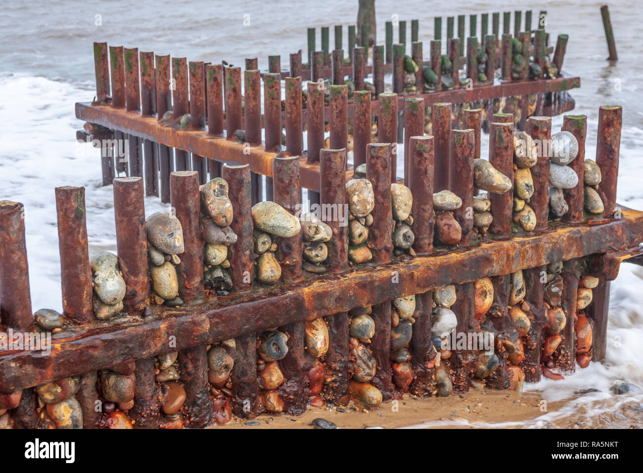 metal beach groynes sea defences on caister beach Stock Photo - Alamy