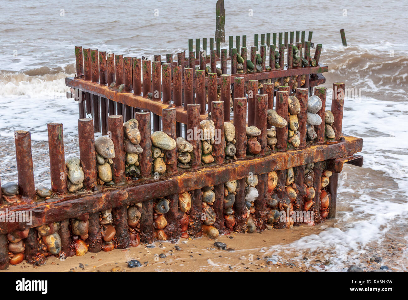metal beach groynes sea defences on caister beach Stock Photo - Alamy