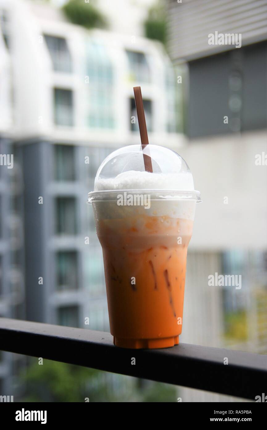 fresh ice milk tea with building background Stock Photo - Alamy