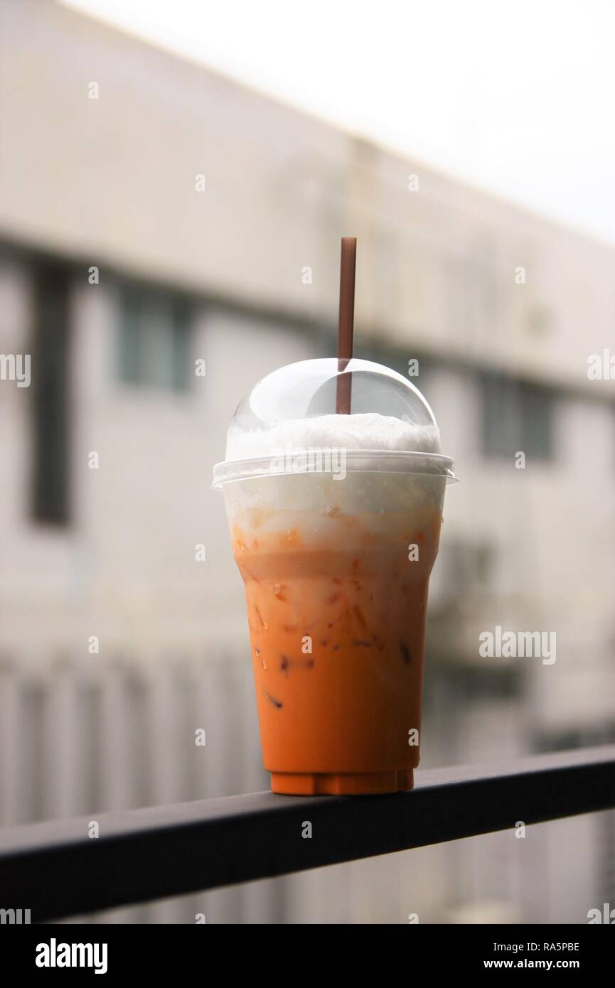 fresh ice milk tea with building background Stock Photo - Alamy