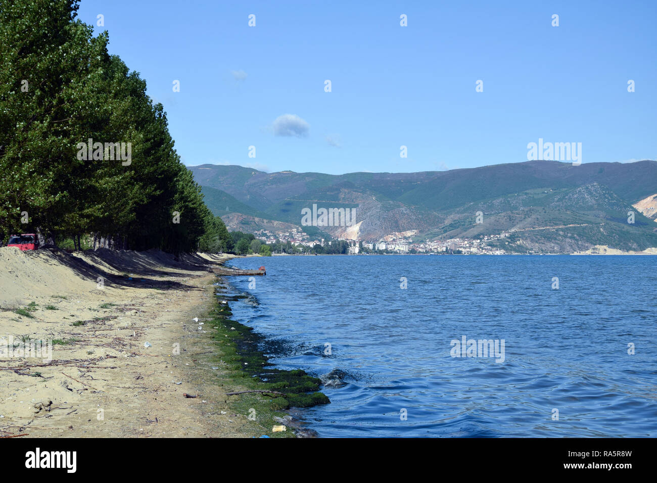 Ohrid Lake shore with old wooden boat. Beach near Pogradec, Tushemisht ...