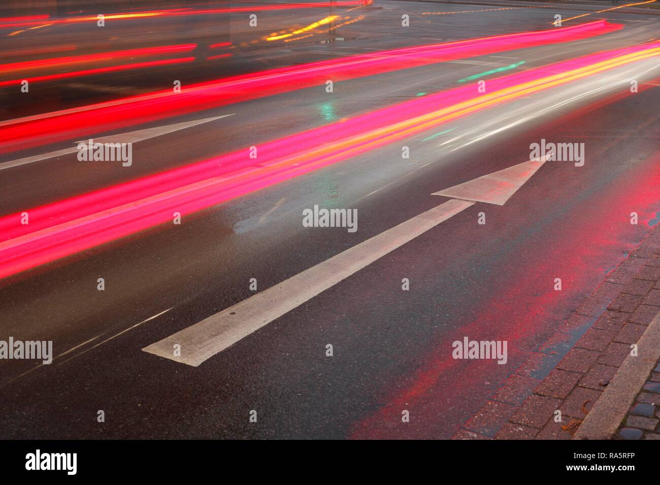 Rainwater street, lights, direction arrow in rain at dusk, Bremen ...