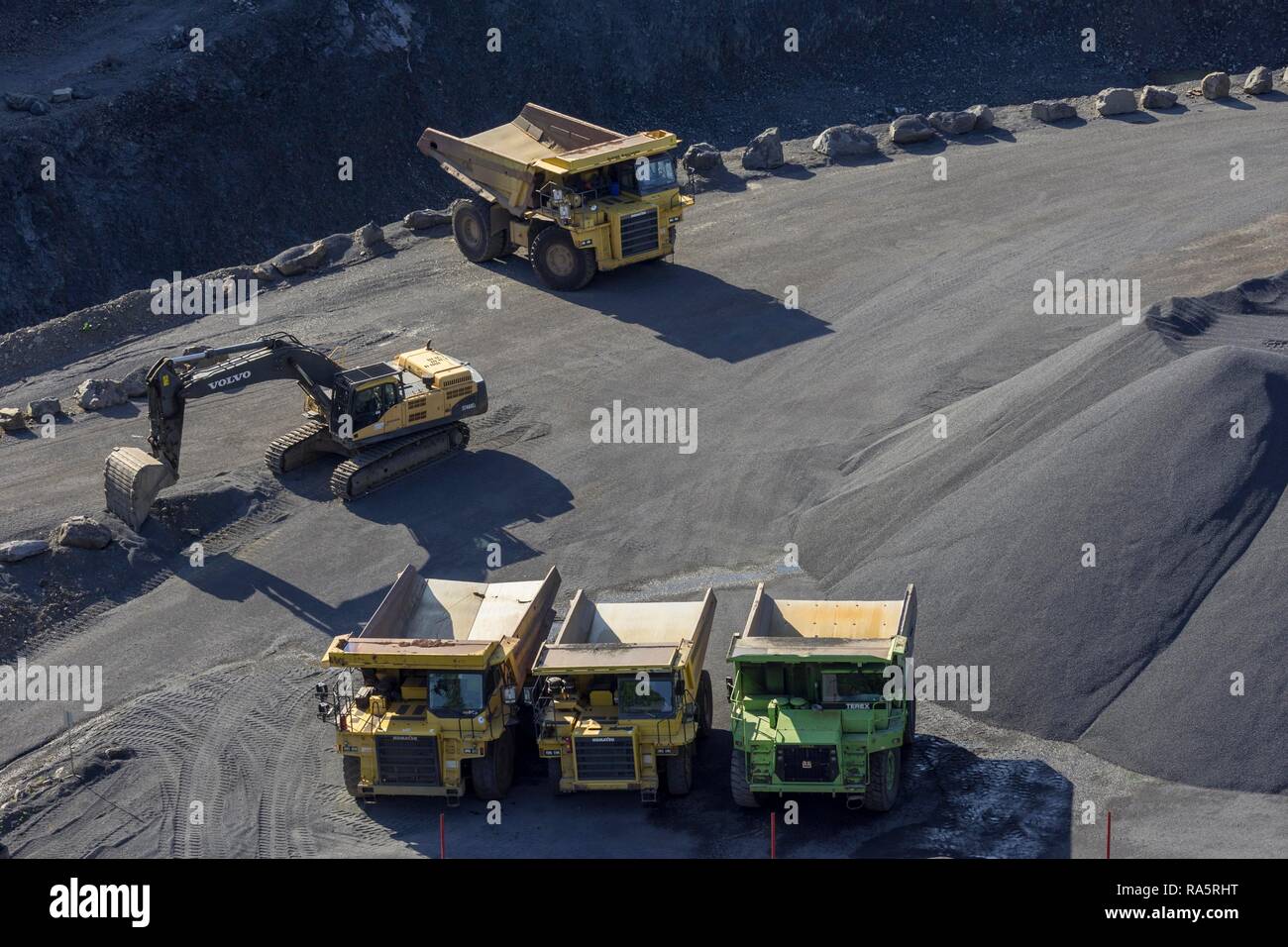 Tipper loader and excavator in a basalt quarry, observation tower Ruine ...