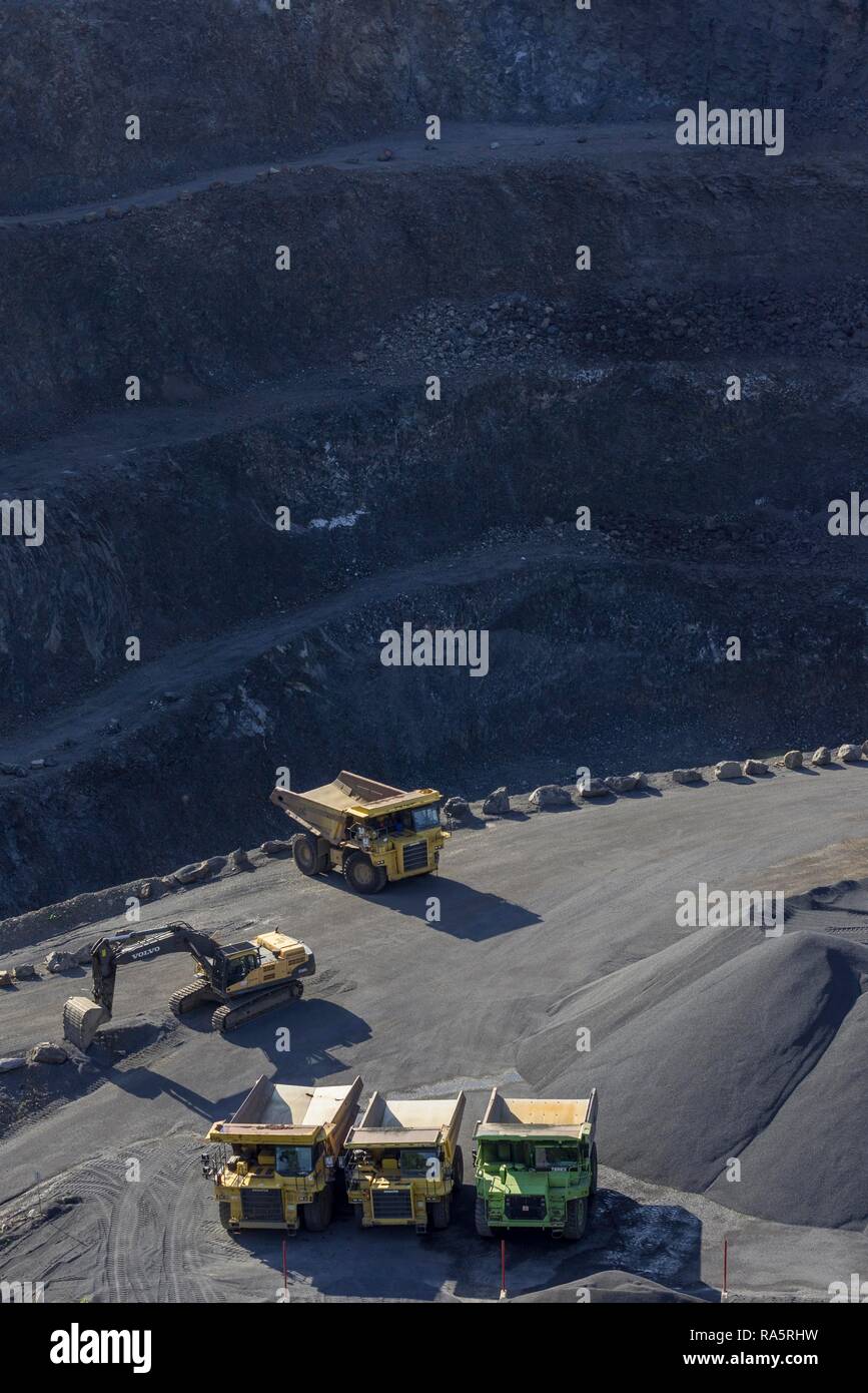 Tipper loader and excavator in a basalt quarry, observation tower Ruine ...