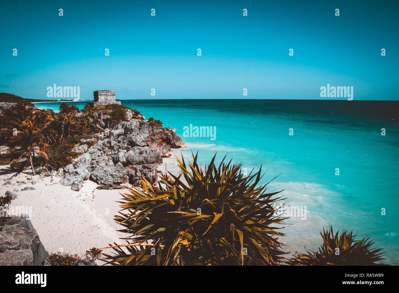 Mayan Temple of the Wind God in Tulum, Mexico. Teal and orange view ...