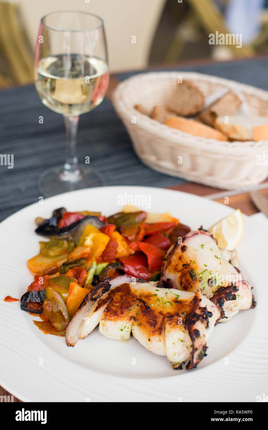 Delicious grilled calamari squid with vegetable on plate Stock Photo ...