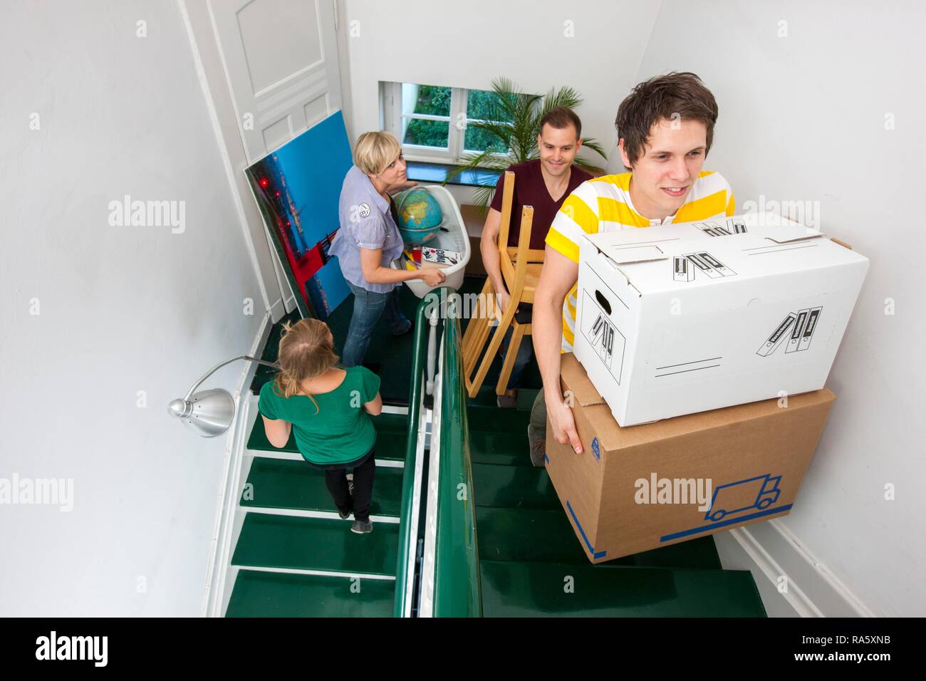 Private house move, friends helping, carrying boxes and furniture up ...