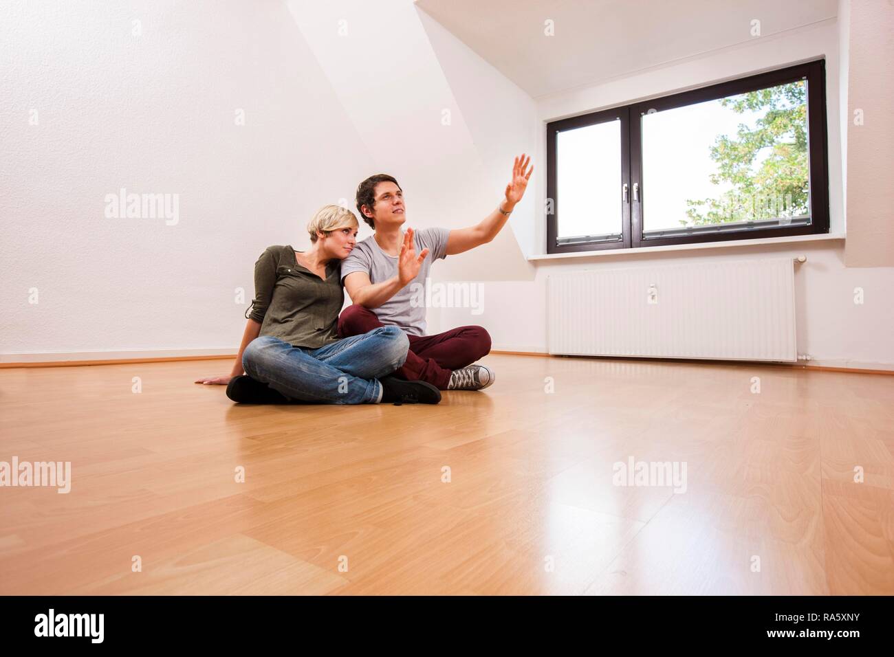 Young couple looking around in a new apartment Stock Photo - Alamy