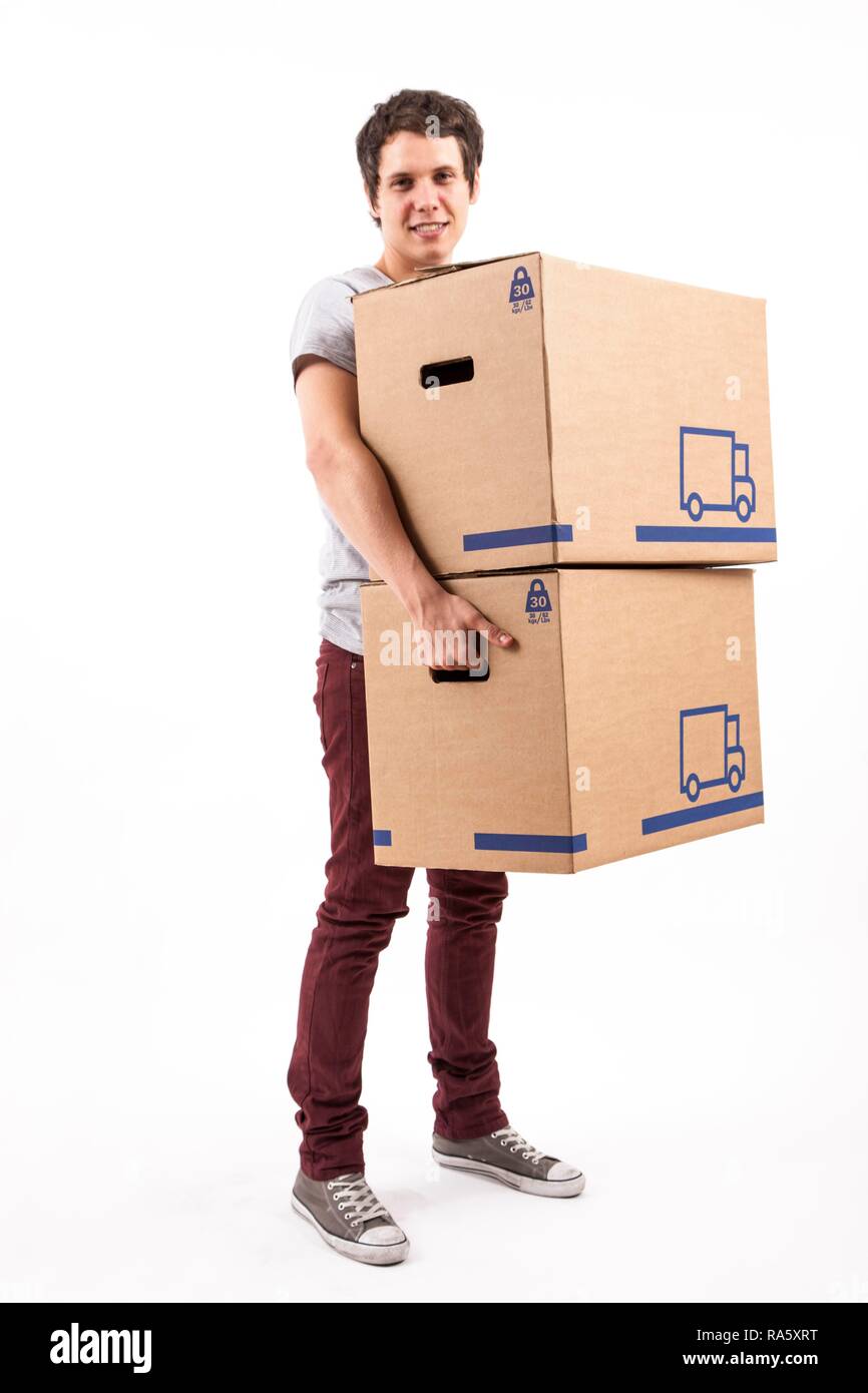 Young man carrying moving boxes Stock Photo - Alamy