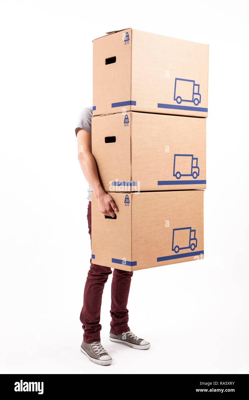 Young man carrying moving boxes Stock Photo - Alamy