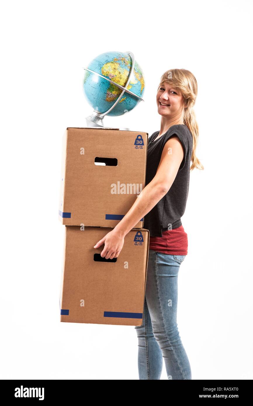 Young woman carrying moving boxes and a globe Stock Photo - Alamy