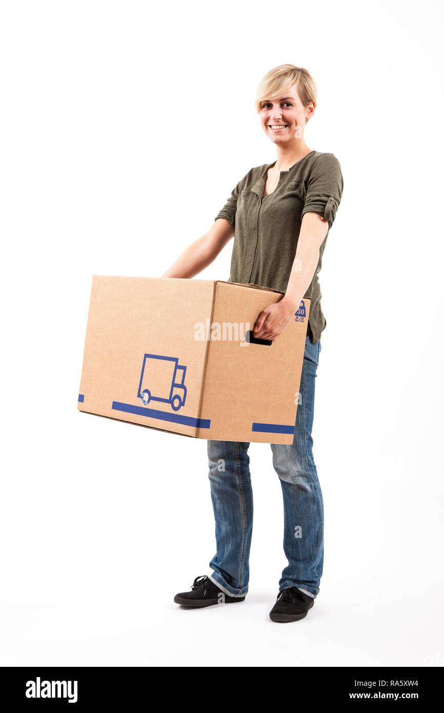 Young woman carrying a moving box Stock Photo - Alamy