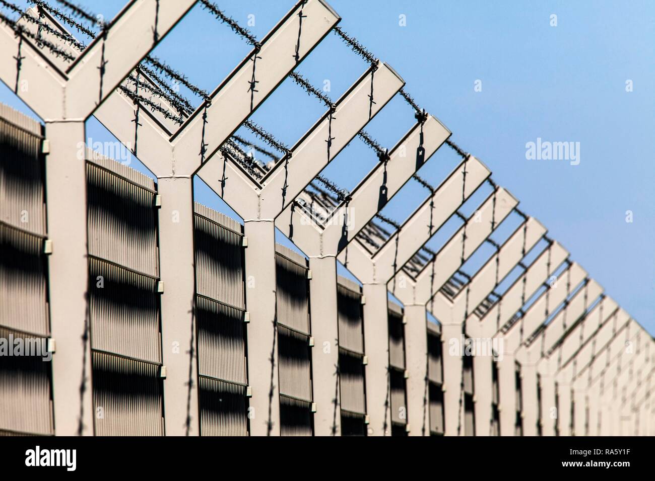 Security fence with barbed wire on top Stock Photo - Alamy