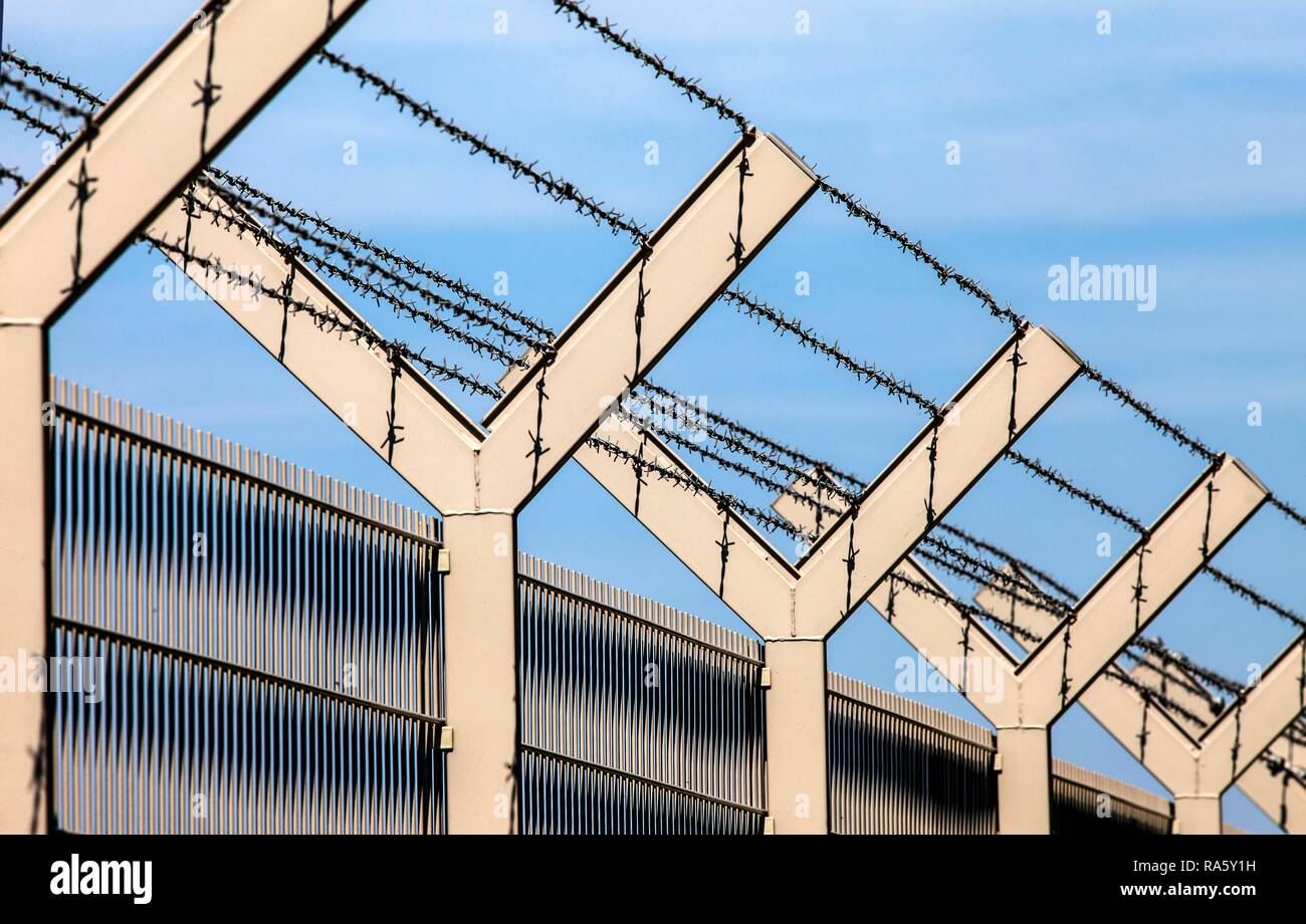 Security fence with barbed wire on top Stock Photo - Alamy