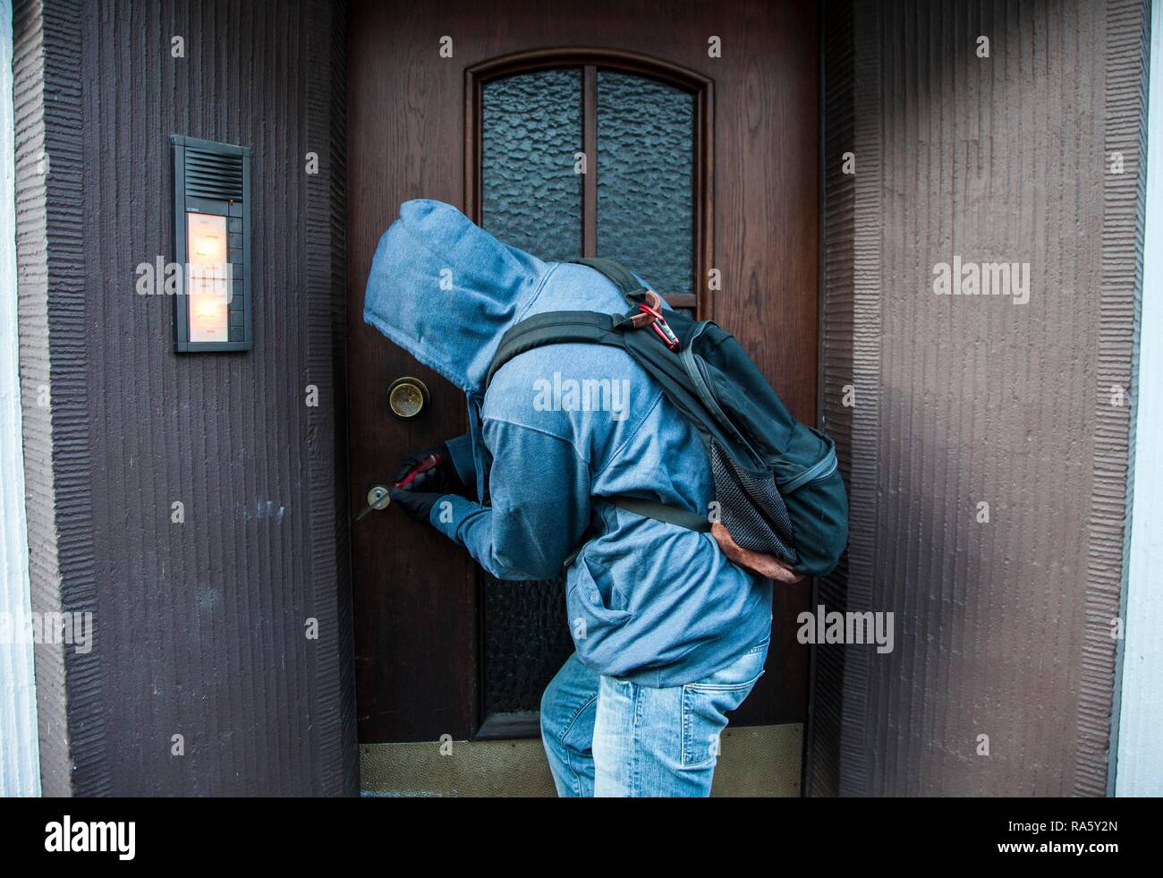 Burglar prying open a door in broad daylight Stock Photo - Alamy