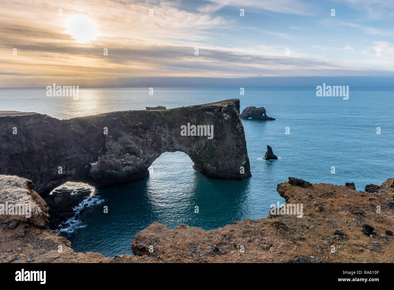 View of the Dyrholaey rock arch in Iceland at sunrise Stock Photo - Alamy