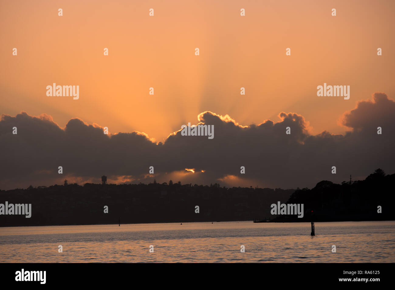 sun rays at sunrise over the water Stock Photo - Alamy