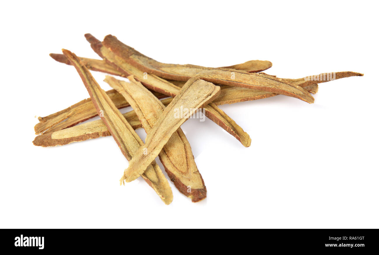 Slice Licorice roots on white background Stock Photo - Alamy