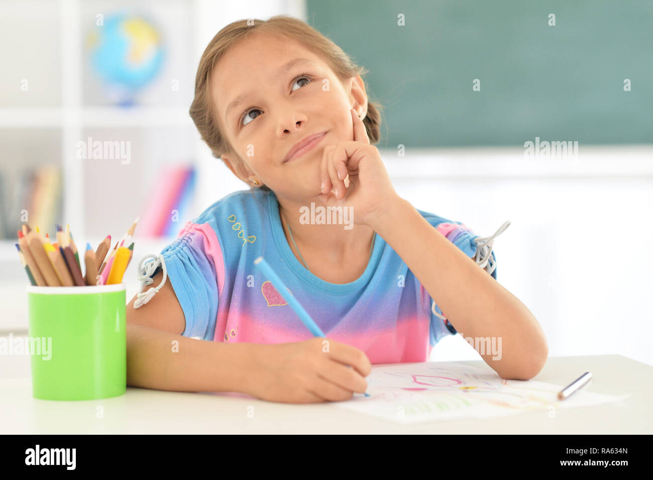 Close up portrait of cute little girl drawing Stock Photo - Alamy